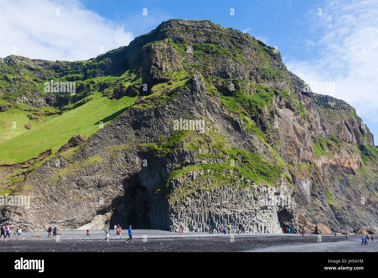 Sea cave and basalt columns on the black sand beach at Reynisfjara in ...