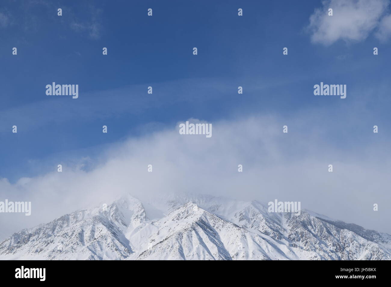Snow Blowing Over Mountains Stock Photo - Alamy