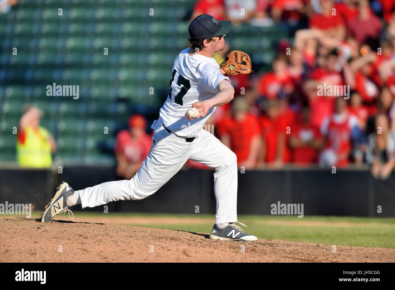 Pitcher delivering a pitch to an opposing hitter during a high school ...
