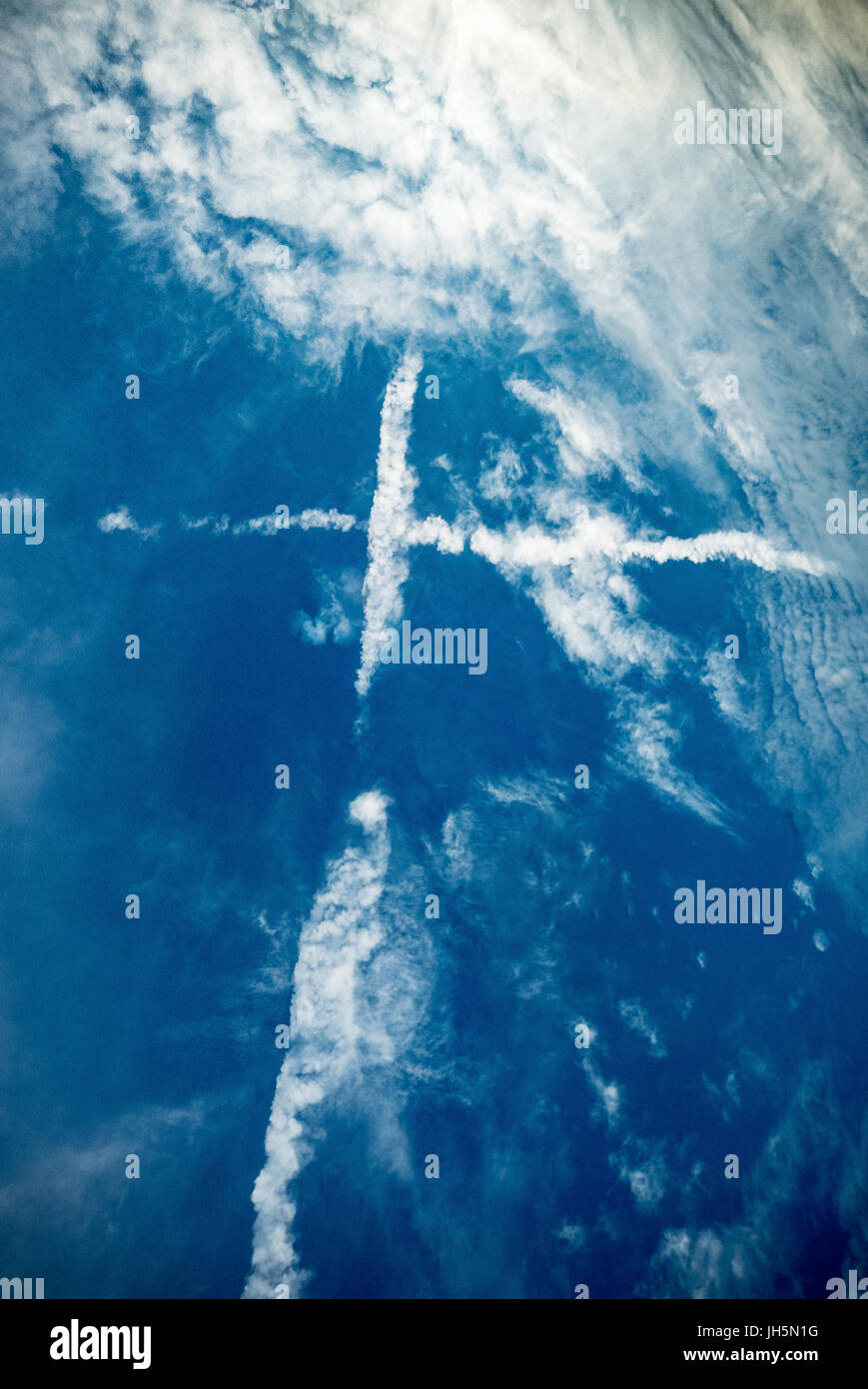 two contrails cross in the evening sky creating a dramatic "cross Stock ...