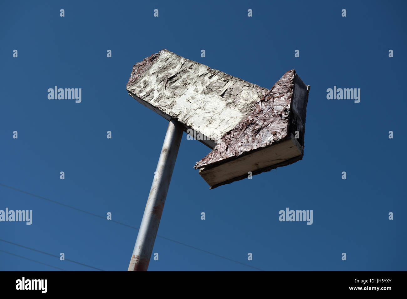 An old weathered wooden arrow sign Stock Photo - Alamy