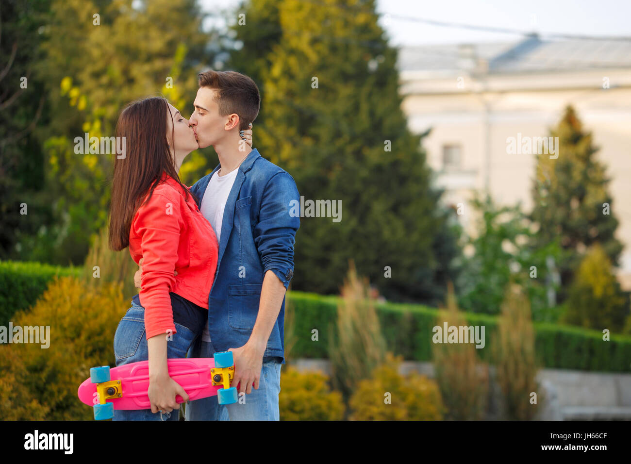 Teenagers on a date. First love. Passionate kiss and strong embrace ...