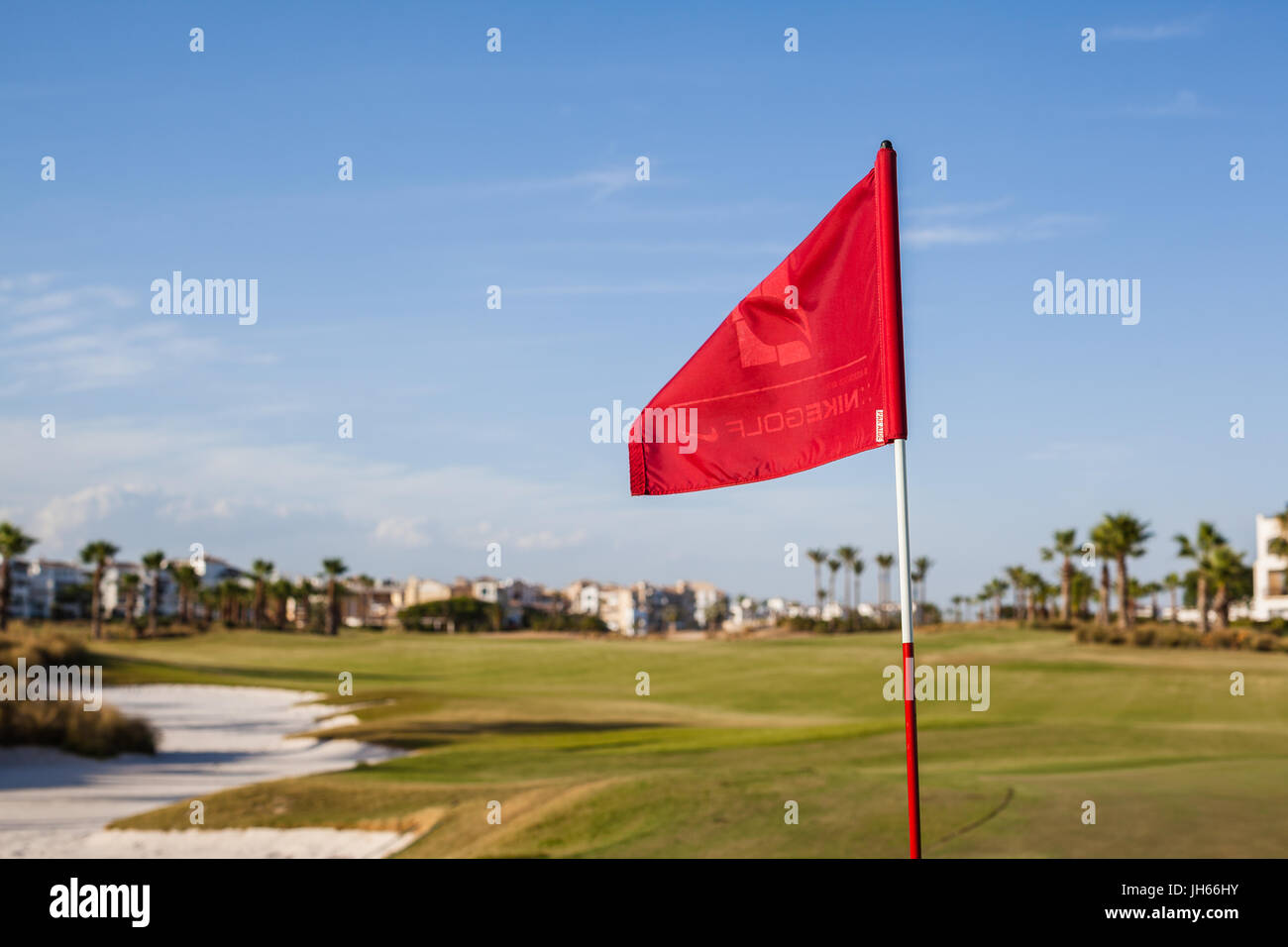 Red golf flag on in the hole of a golf course Stock Photo - Alamy