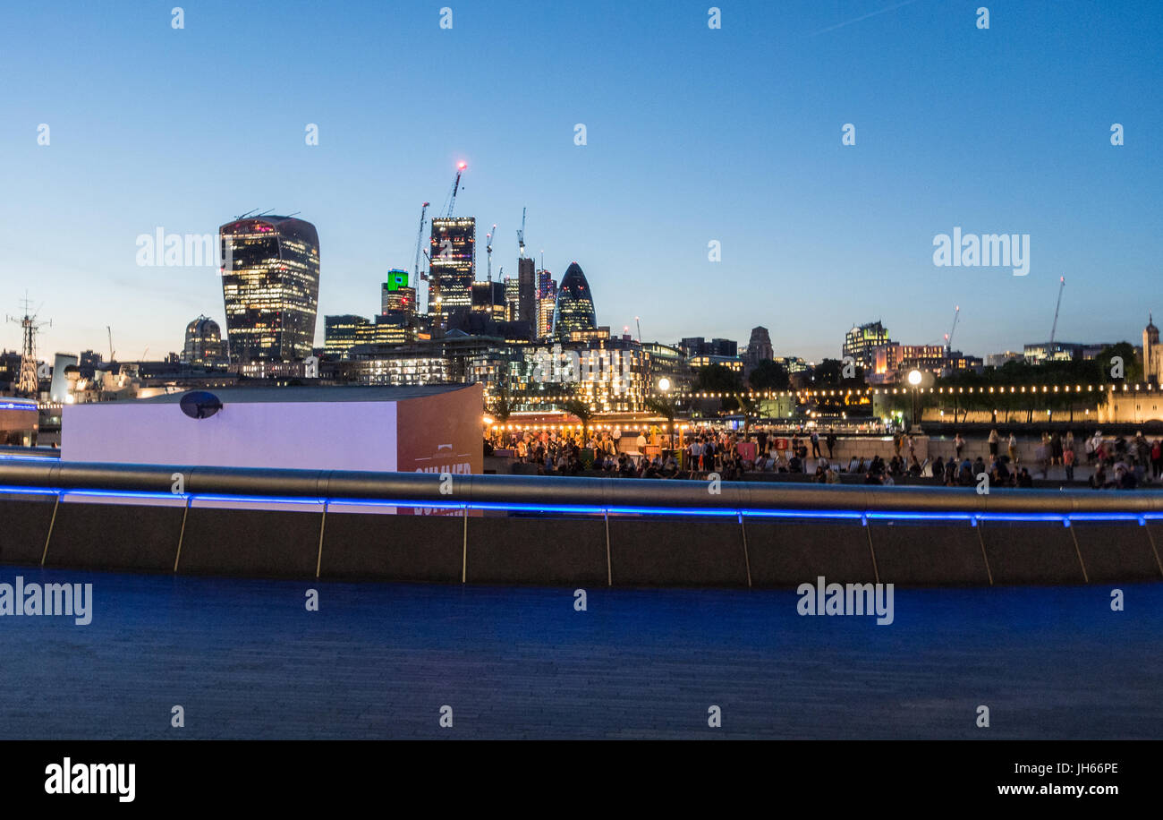 A music festival takes place at More London with City of London lit up ...