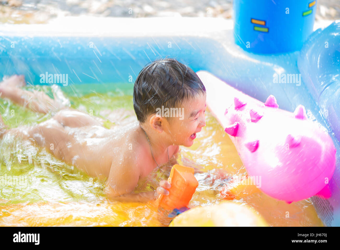 Asian boy playing in waterfall hi-res stock photography and images - Alamy