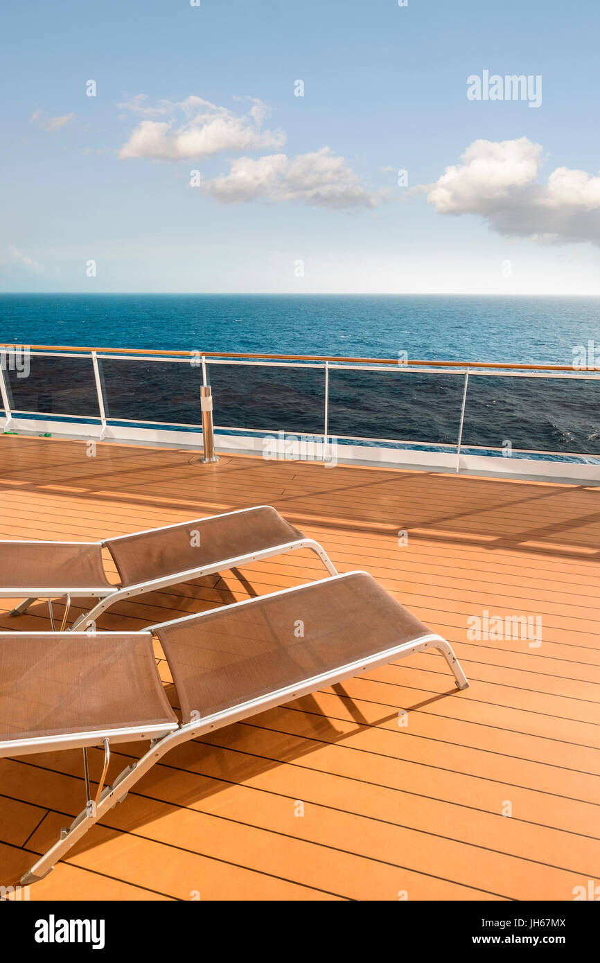 Cruise ship deck with sun loungers out at sea Stock Photo - Alamy