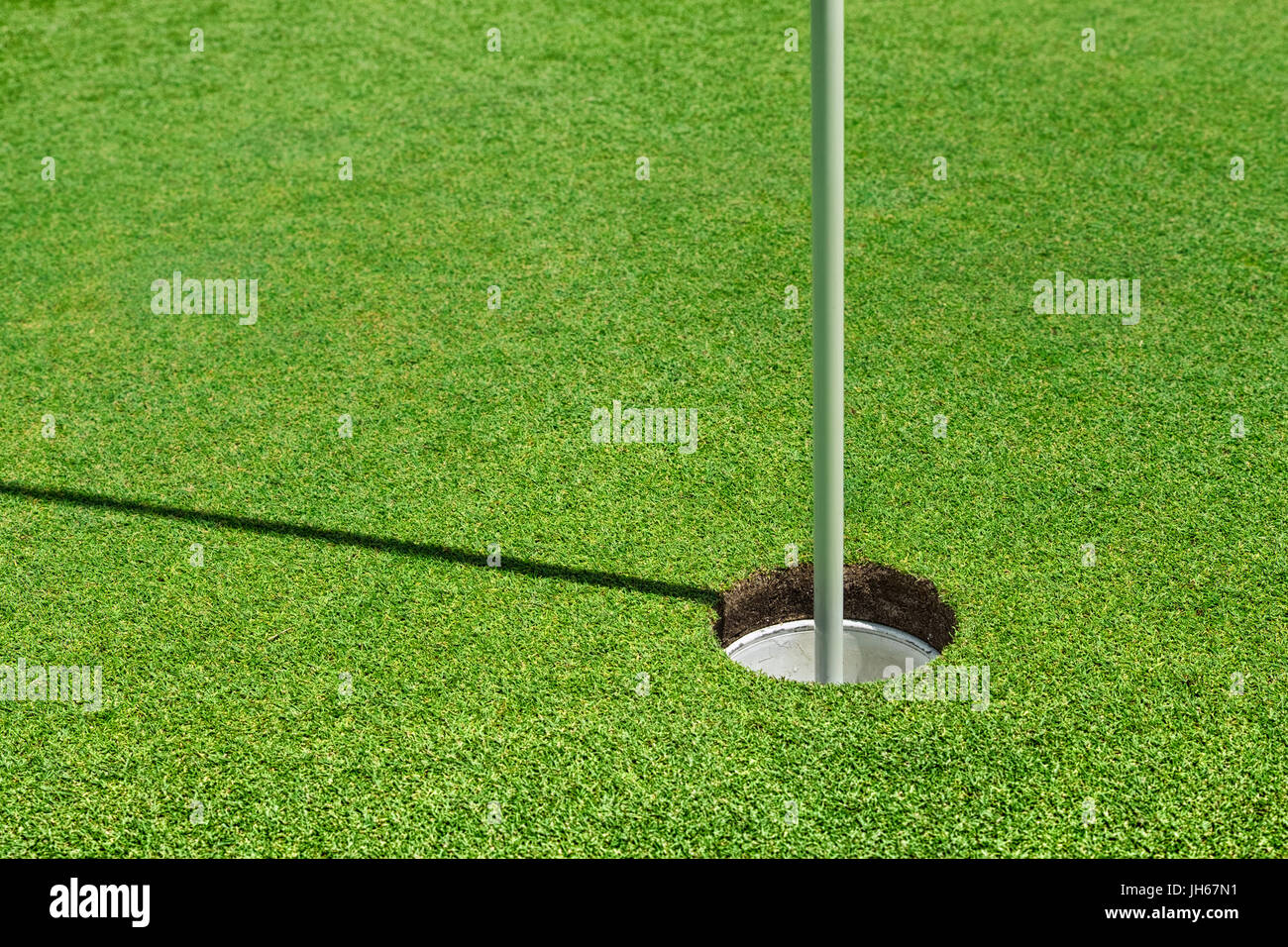 Golf hole on the putting green Stock Photo - Alamy