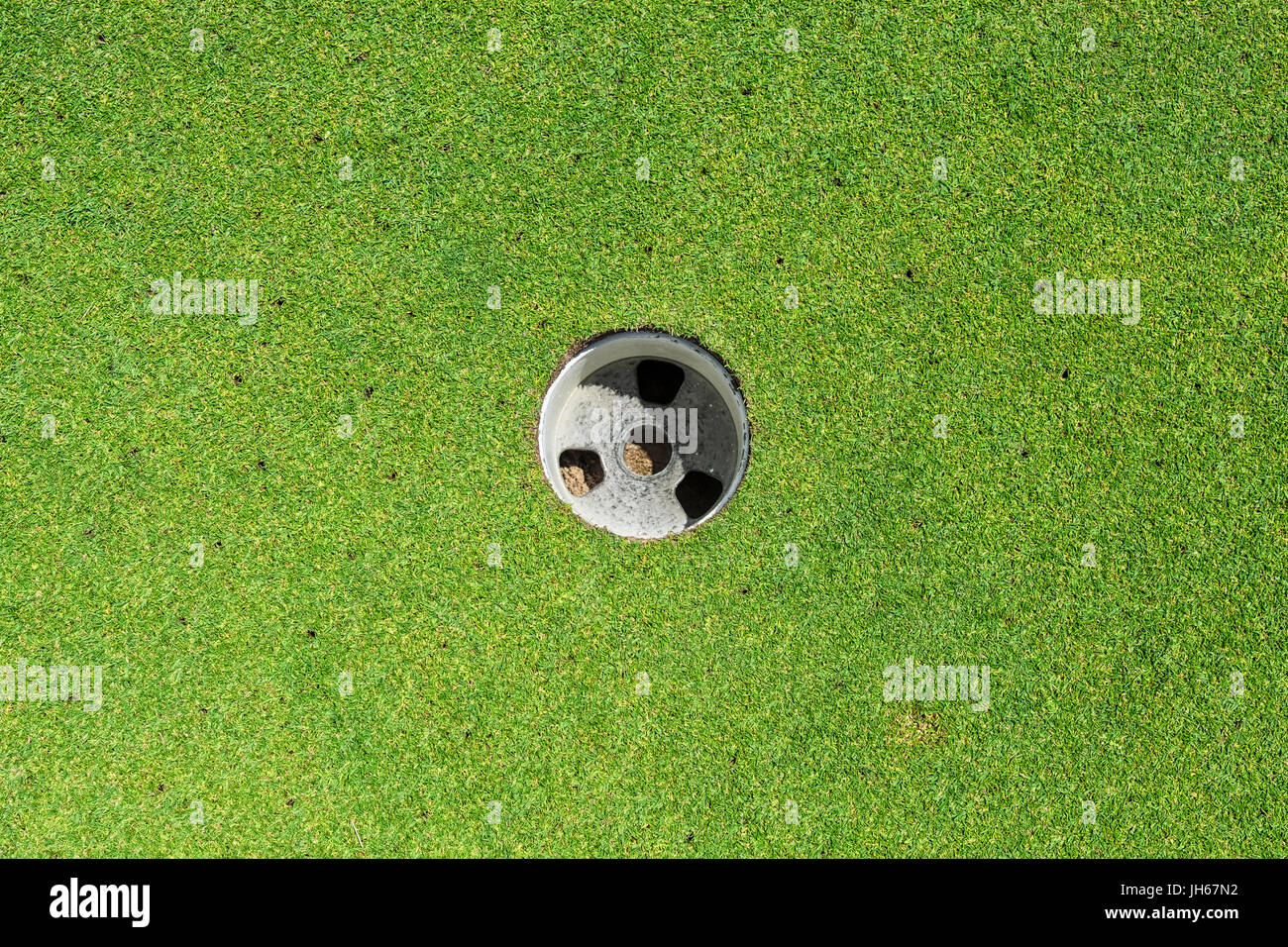 Golf hole on the putting green Stock Photo - Alamy