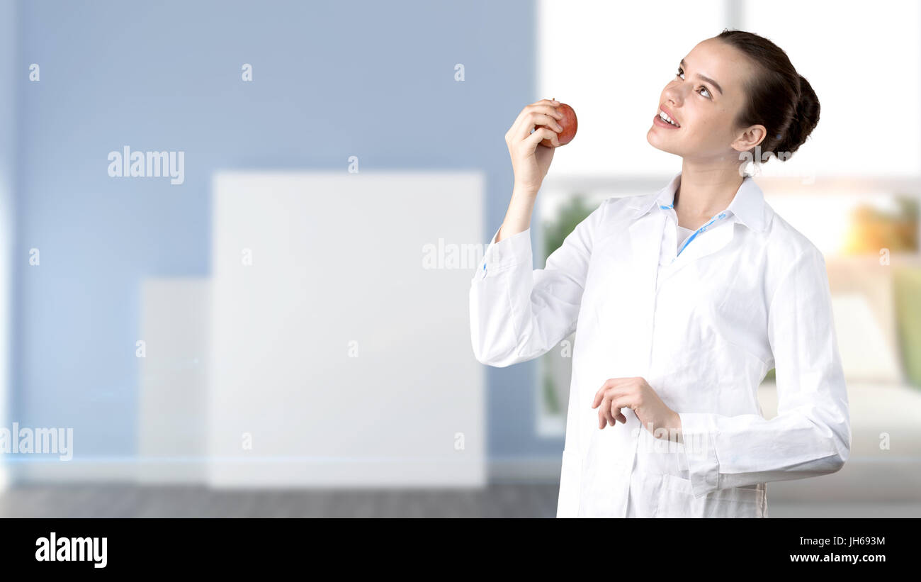 Beautiful medical woman doctor in uniform. Studio painted background ...
