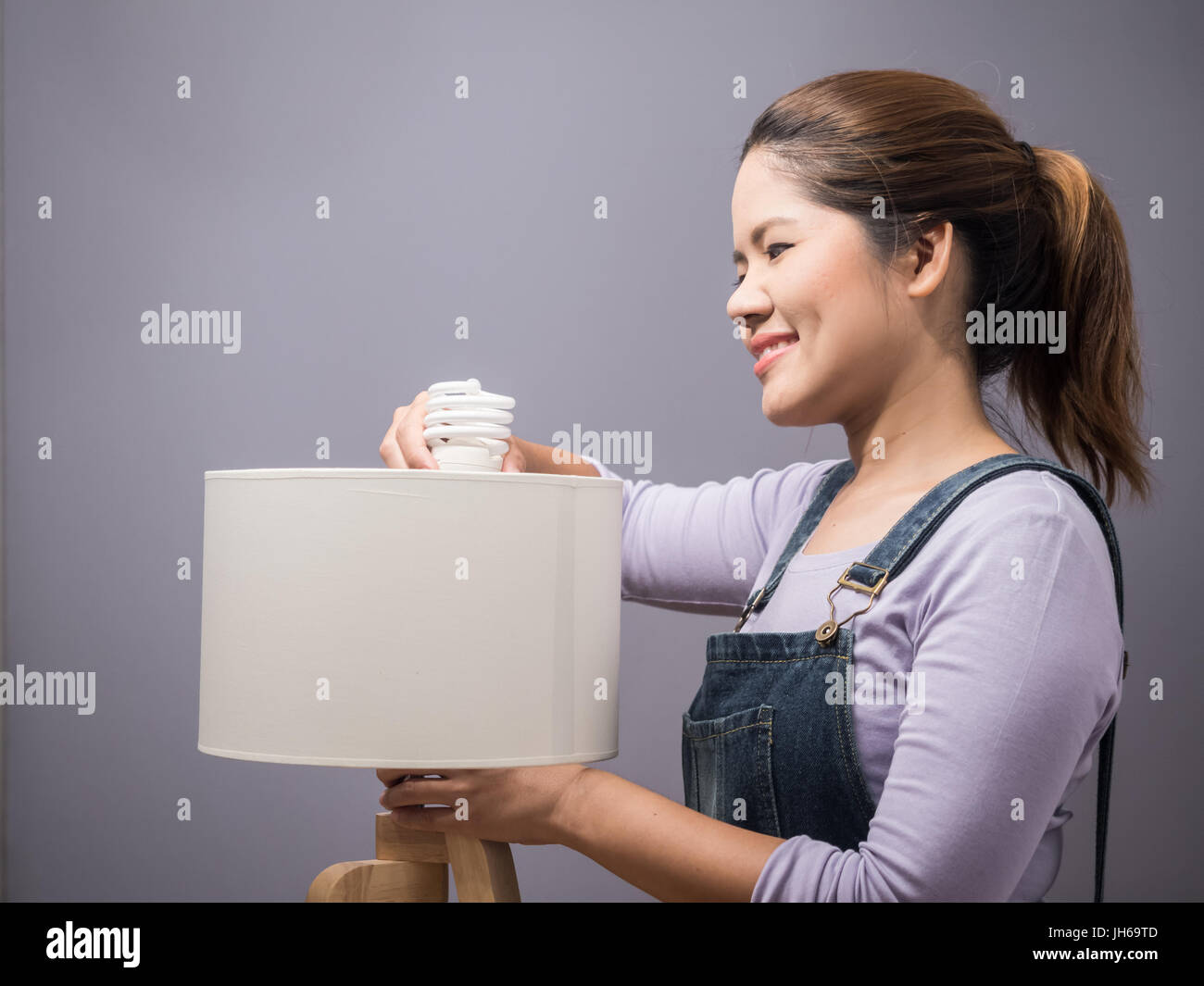 asian woman changing light bulb Stock Photo - Alamy
