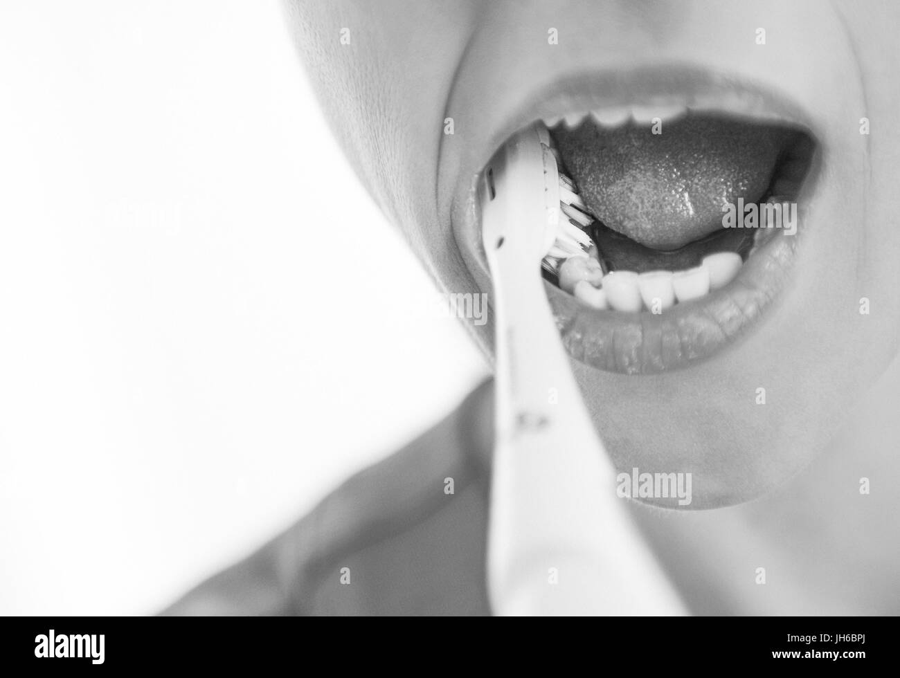 Closeup on young woman brushing teeth Stock Photo - Alamy