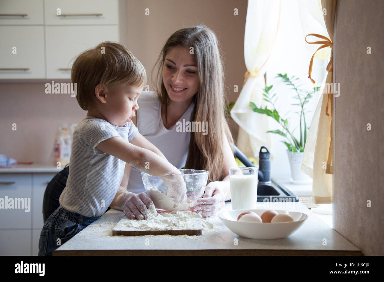 mother and young son prepare a cake in the kitchen Stock Photo - Alamy