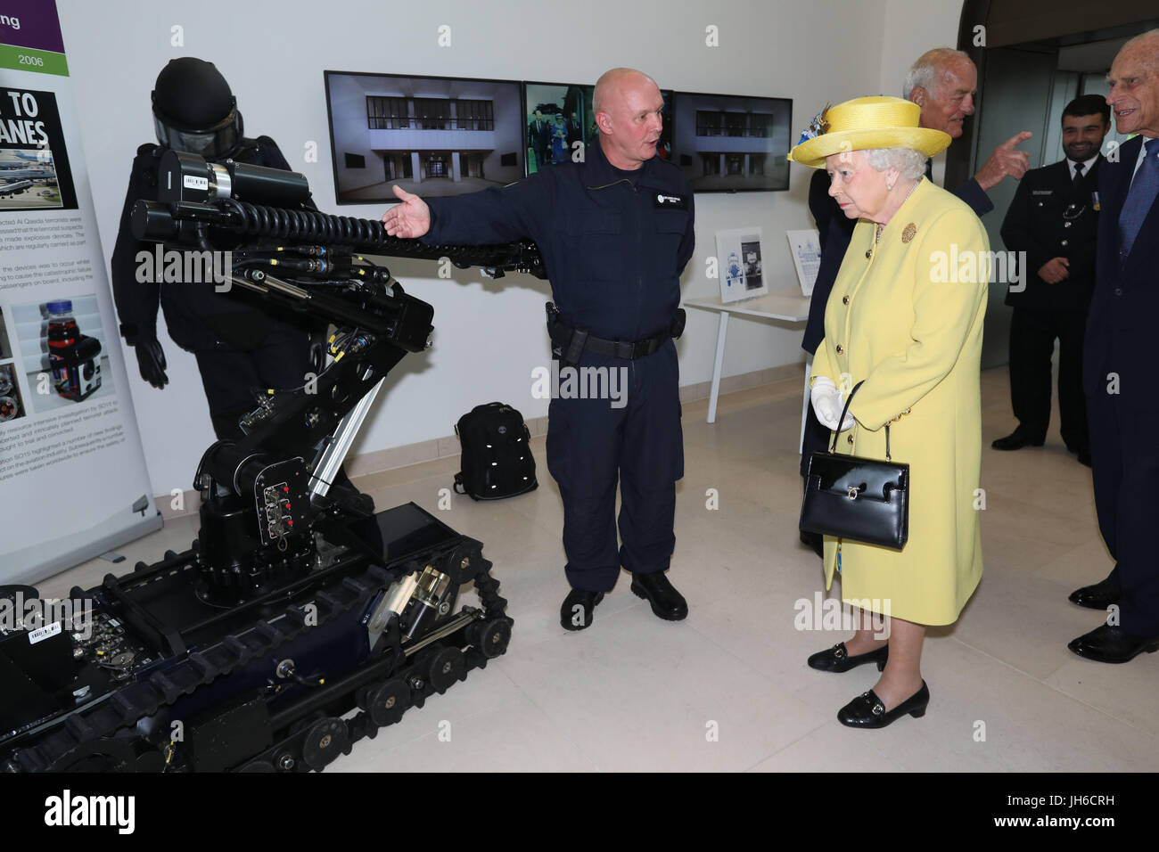 Queen Elizabeth II looks at a bomb disposal robot during the opening of ...