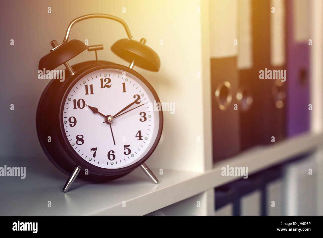Classic alarm clock showing time during working hours or work break in ...