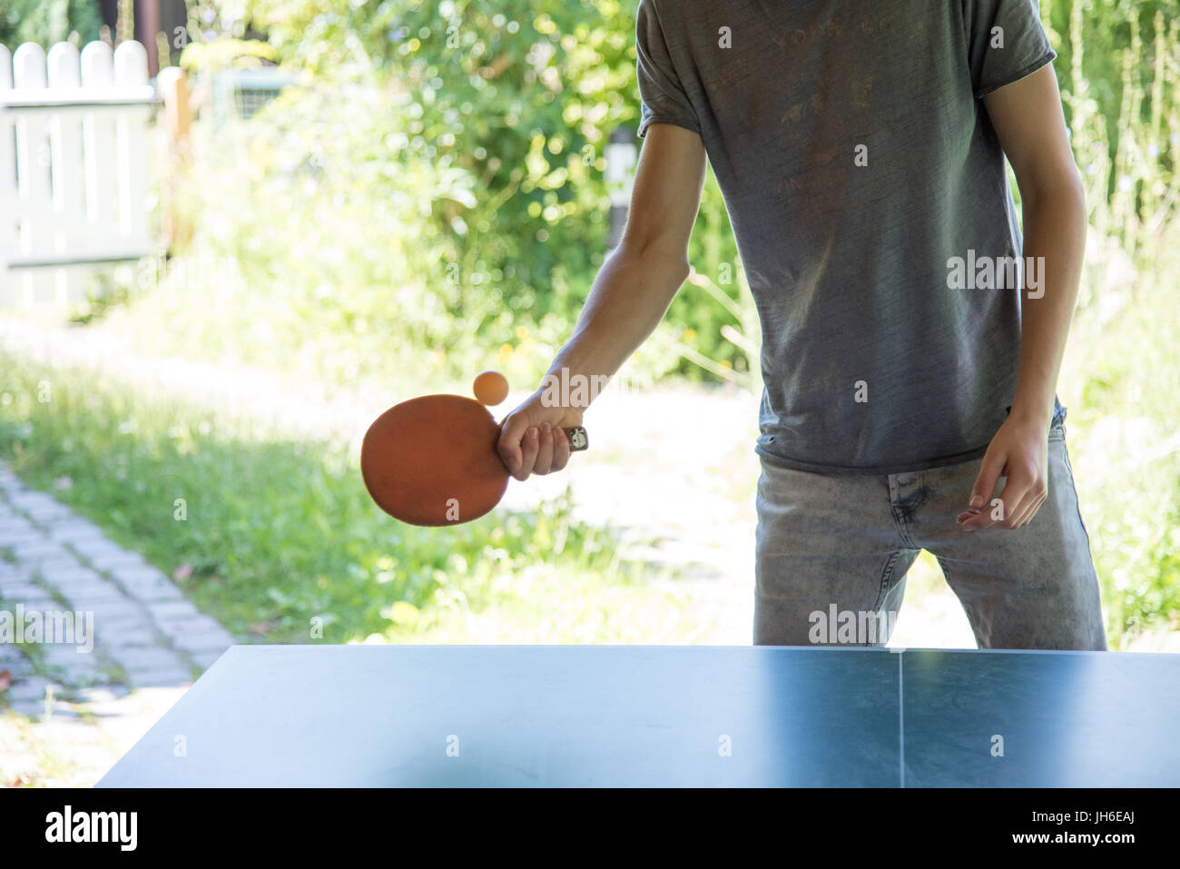 A young man playing ping-pong or table tennis Stock Photo - Alamy
