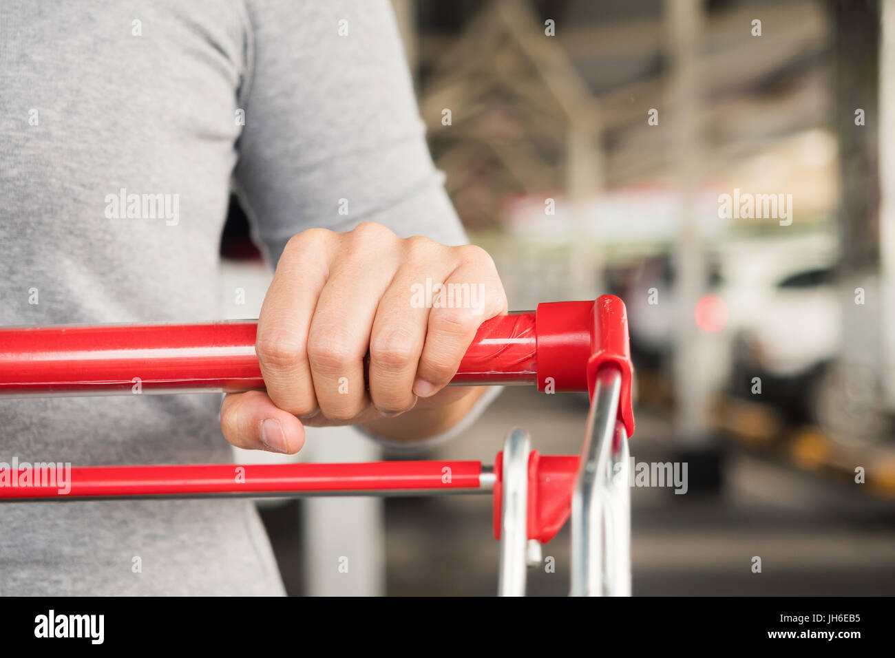 hand holding shopping cart Stock Photo - Alamy