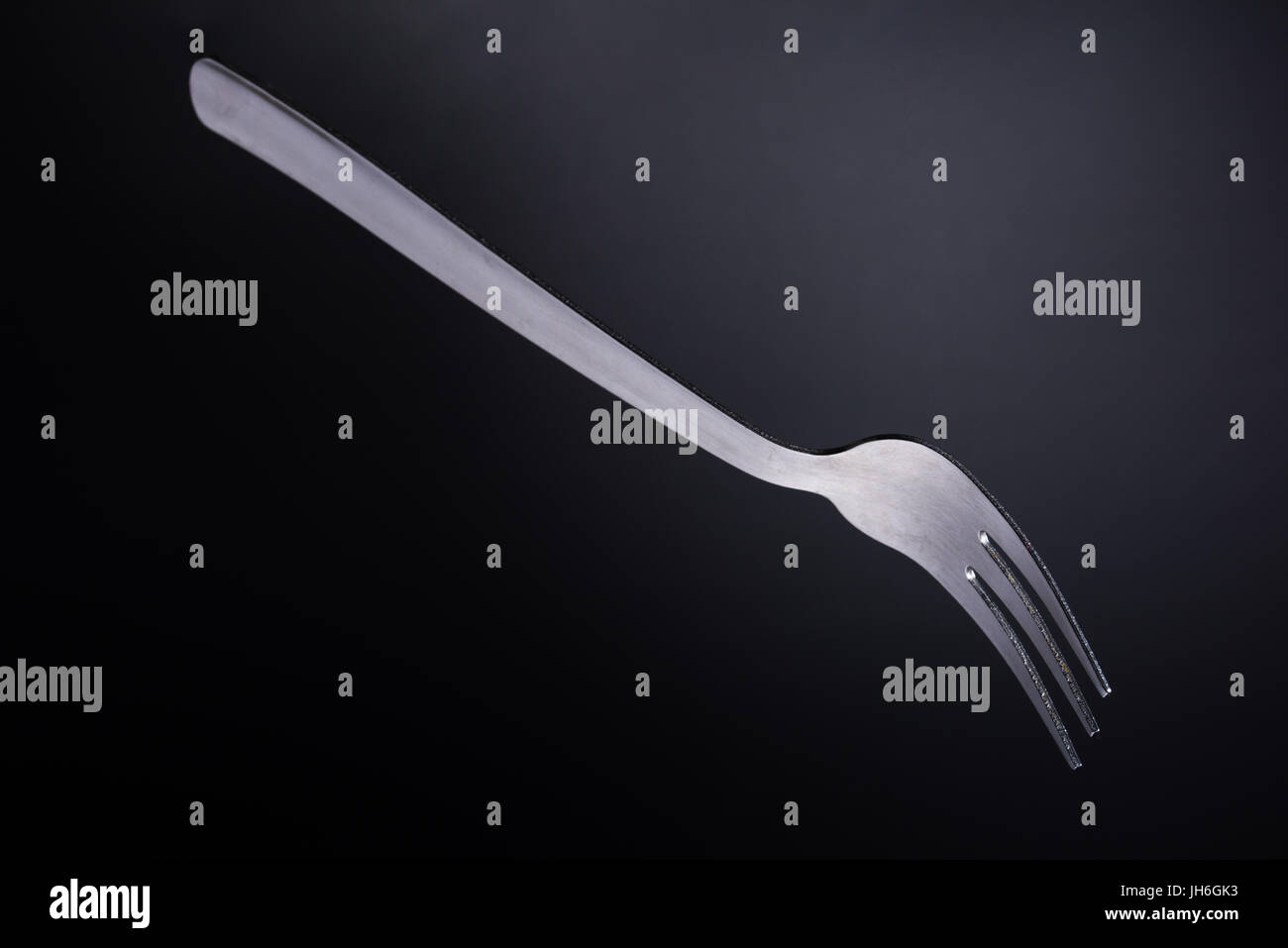 Fork in black background Stock Photo - Alamy
