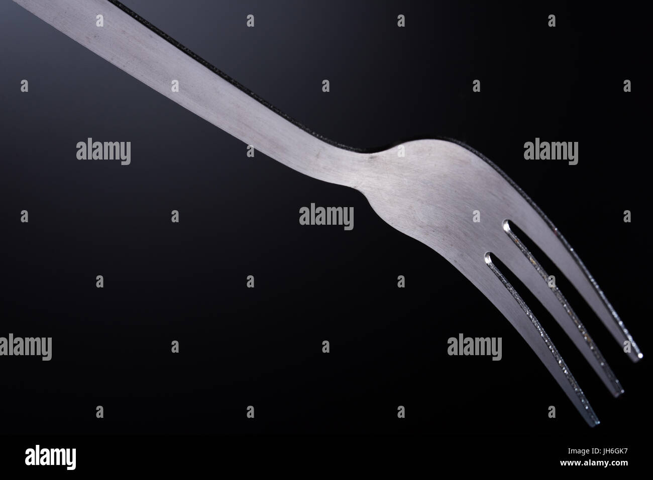 Fork in black background Stock Photo - Alamy
