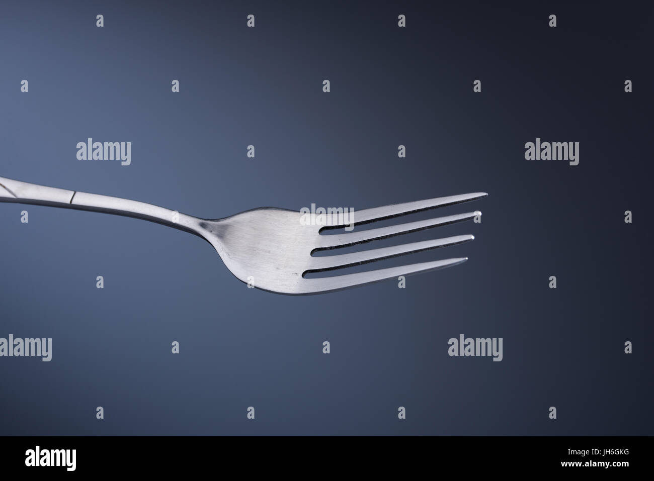 Fork in black background Stock Photo - Alamy