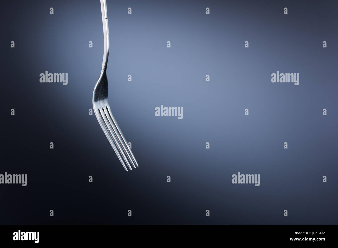 Fork in black background Stock Photo - Alamy