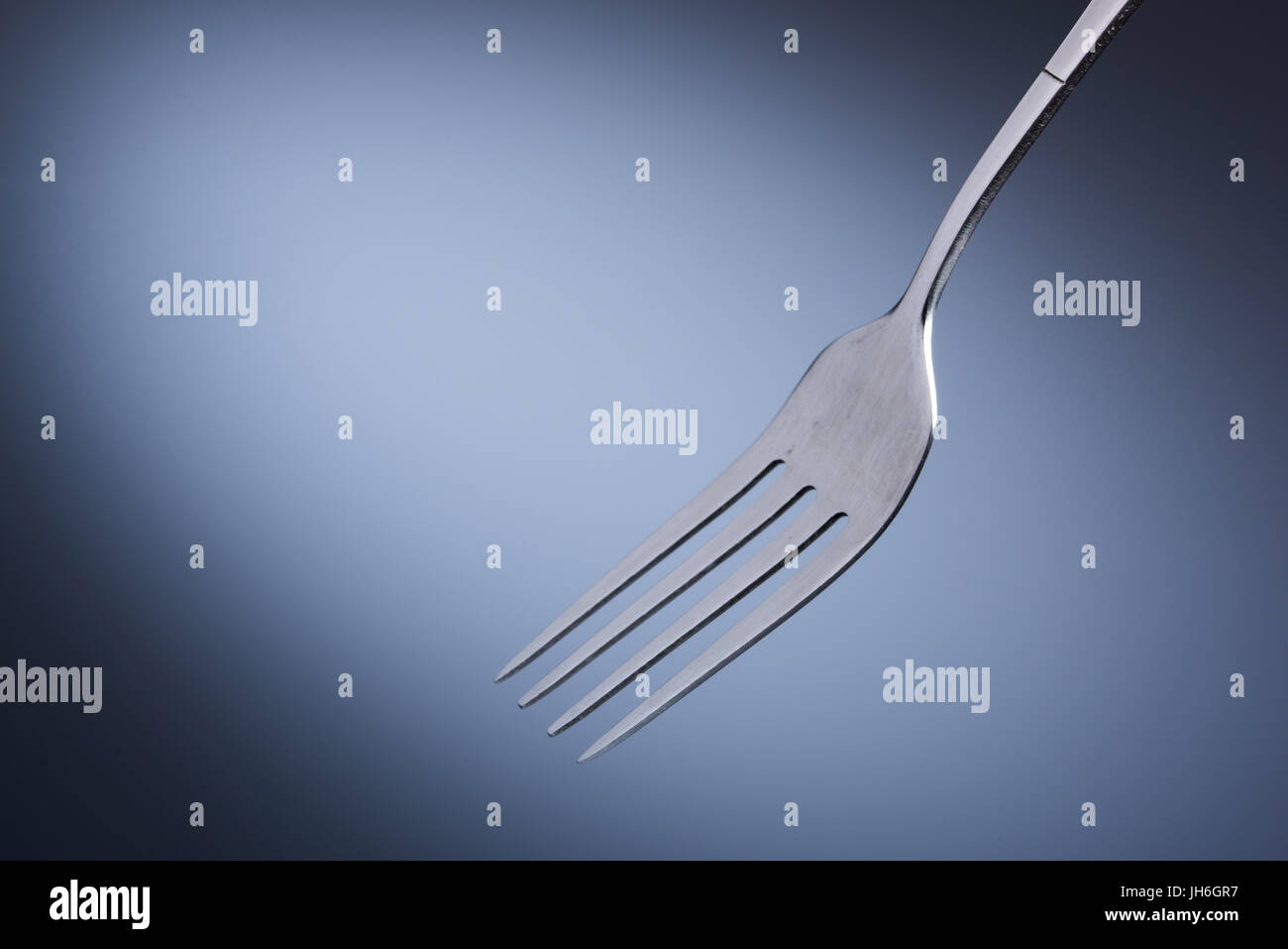 Fork in black background Stock Photo - Alamy