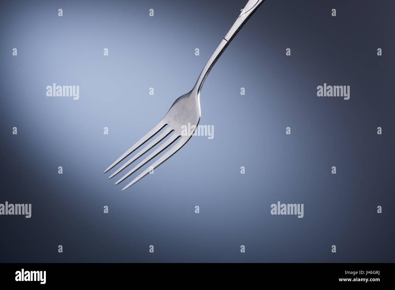 Fork in black background Stock Photo - Alamy