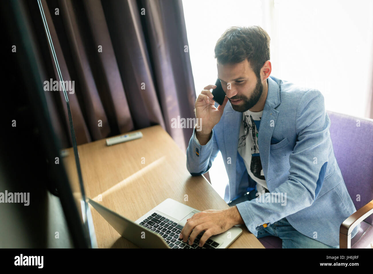 Handsome male worker laptop hi-res stock photography and images - Alamy