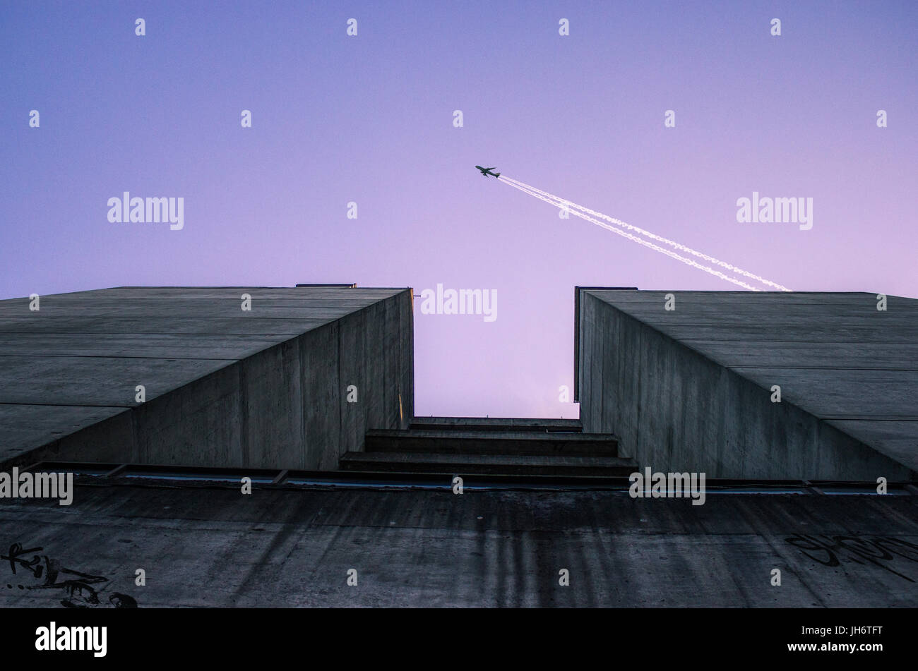 A plane flying over a tall building in Vancouver, B.C on a clear day ...