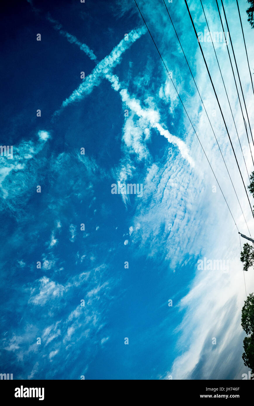 two contrails cross in the evening sky creating a dramatic "cross Stock ...