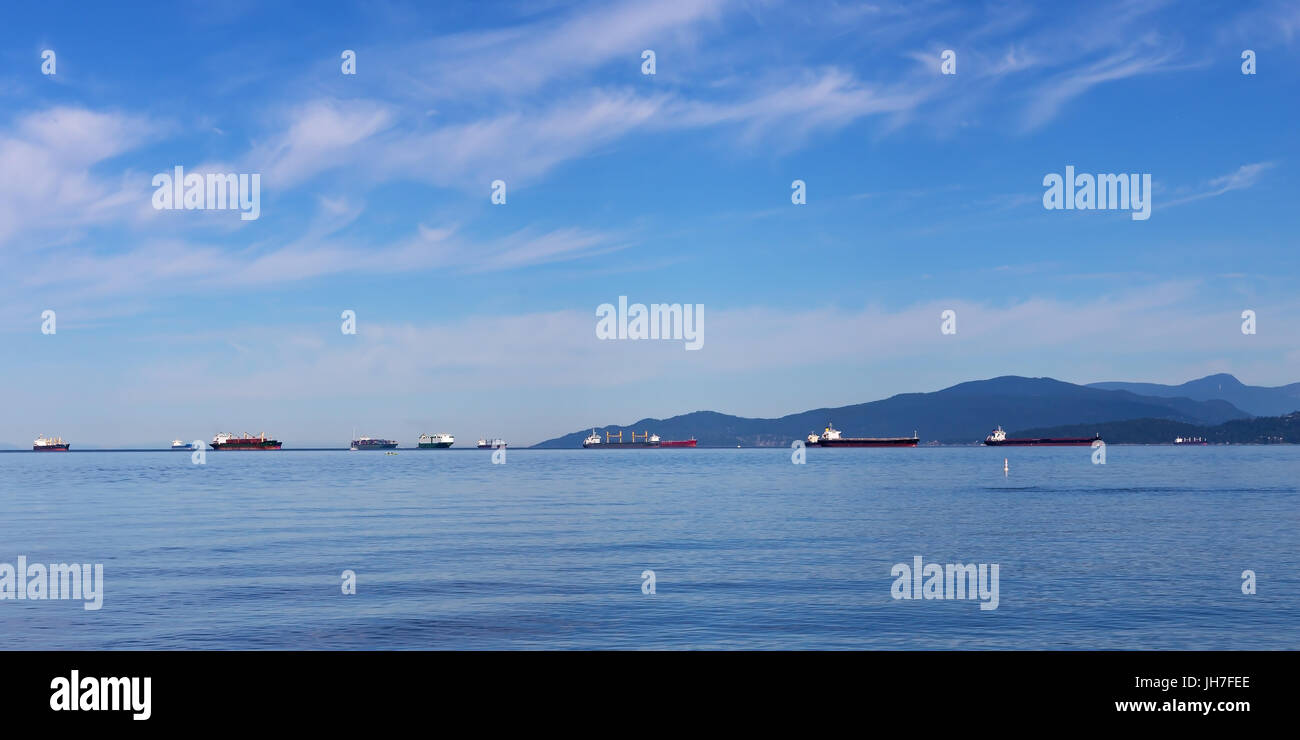 Ships in the roadstead. Peaceful sea with ships and mountain on horizon ...