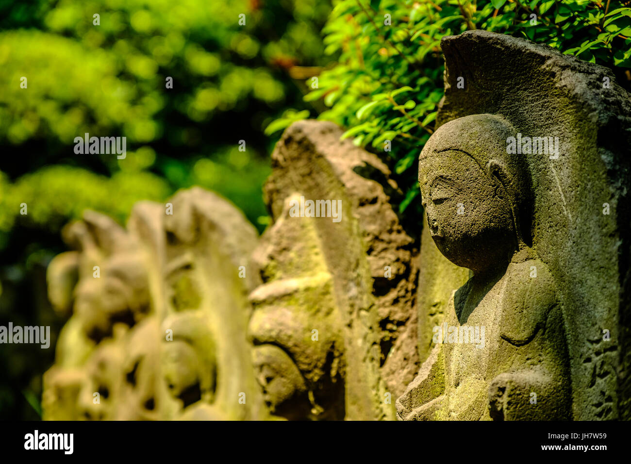 Stone Buddhist statues at a temple in Japan Stock Photo - Alamy