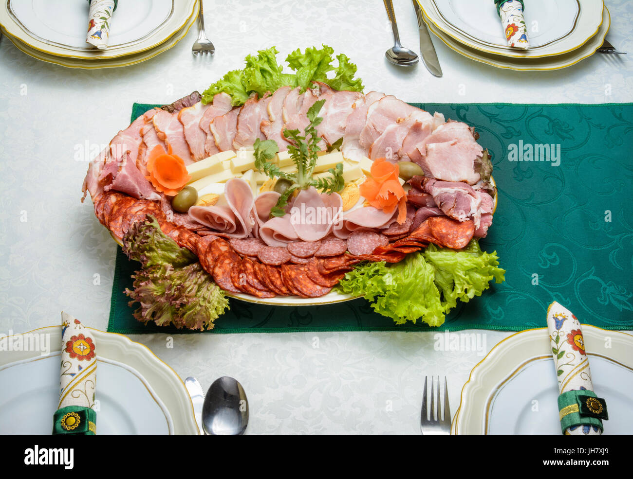 Appetizer platter surrounded with partially visible tableware. Dining ...