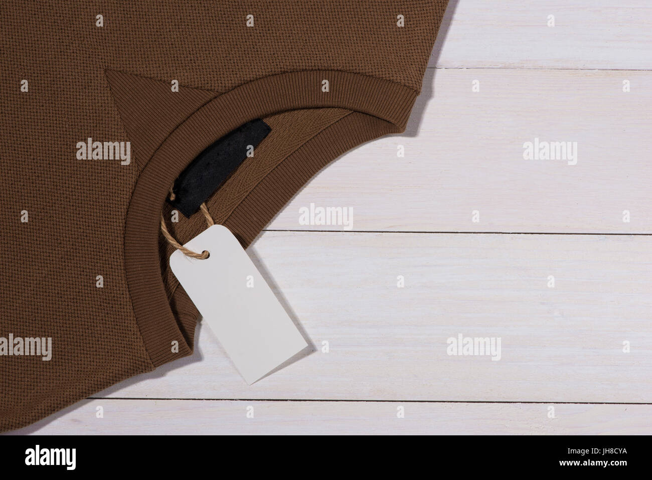 Shirt price tag. Rectangular tag is attached to a sweater Stock Photo ...