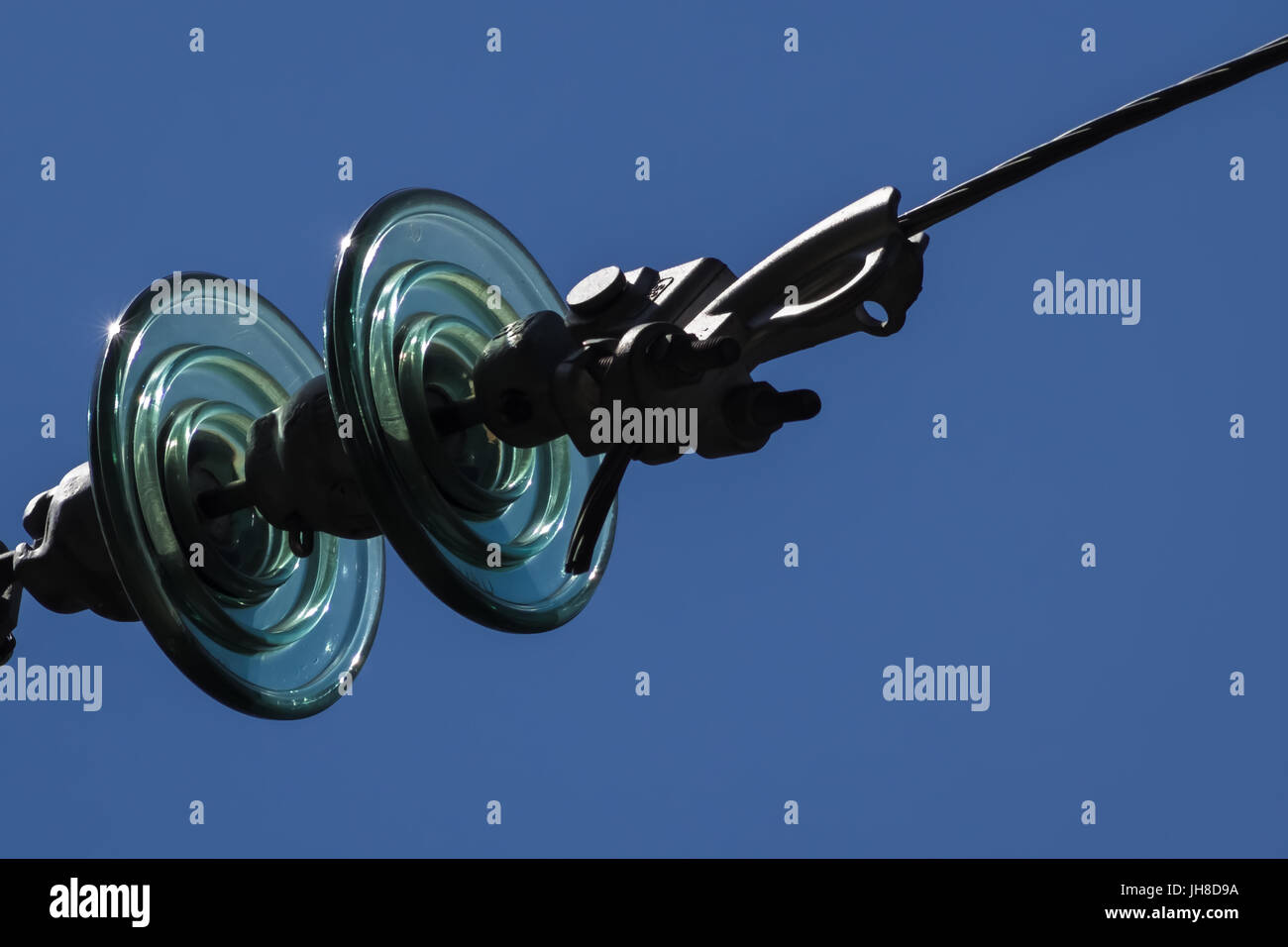 Electric wires with insulators are stretched out on top on a sky ...