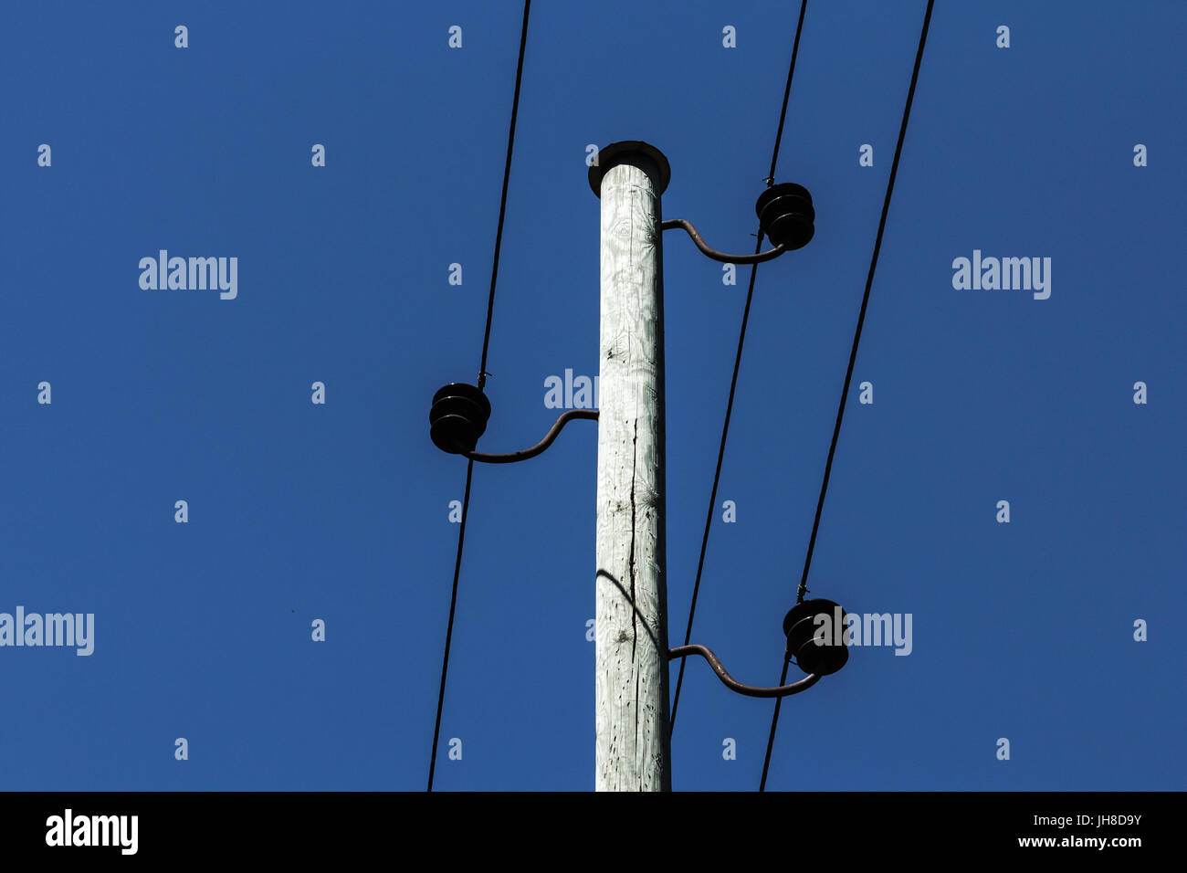 Electric wires with insulators are stretched out on top on a sky ...