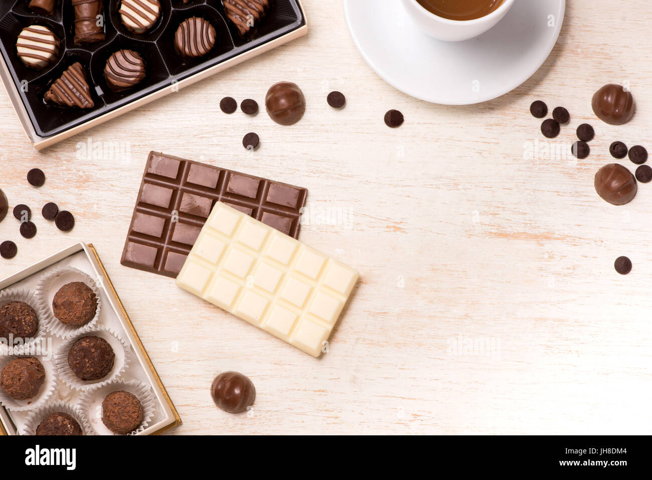 Glass of chocolate milk and variety chocolates on table Stock Photo - Alamy
