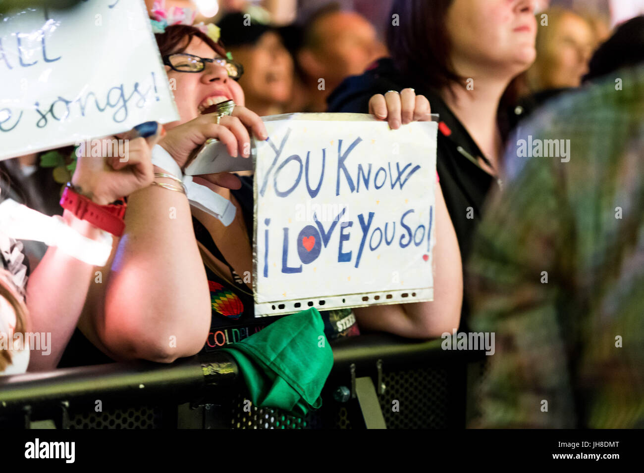 Fans in the crowd watch Coldplay perform at the Principality Stadium ...