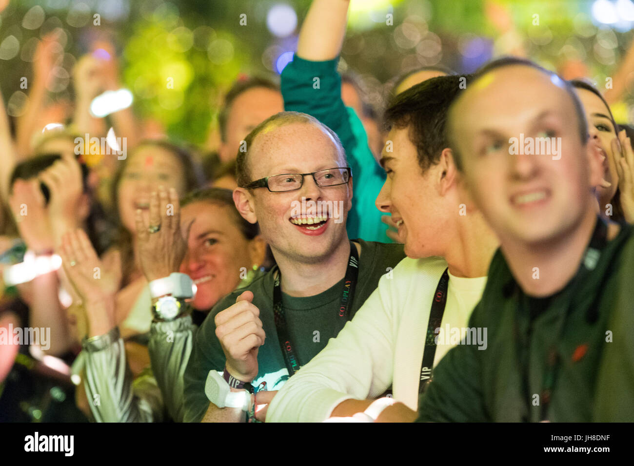 Fans in the crowd watch Coldplay perform at the Principality Stadium ...