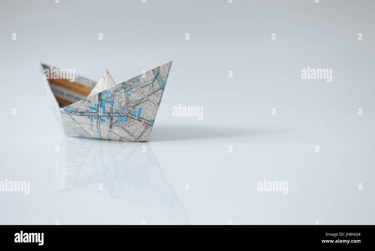 Paper ships from the map on a white Stock Photo - Alamy