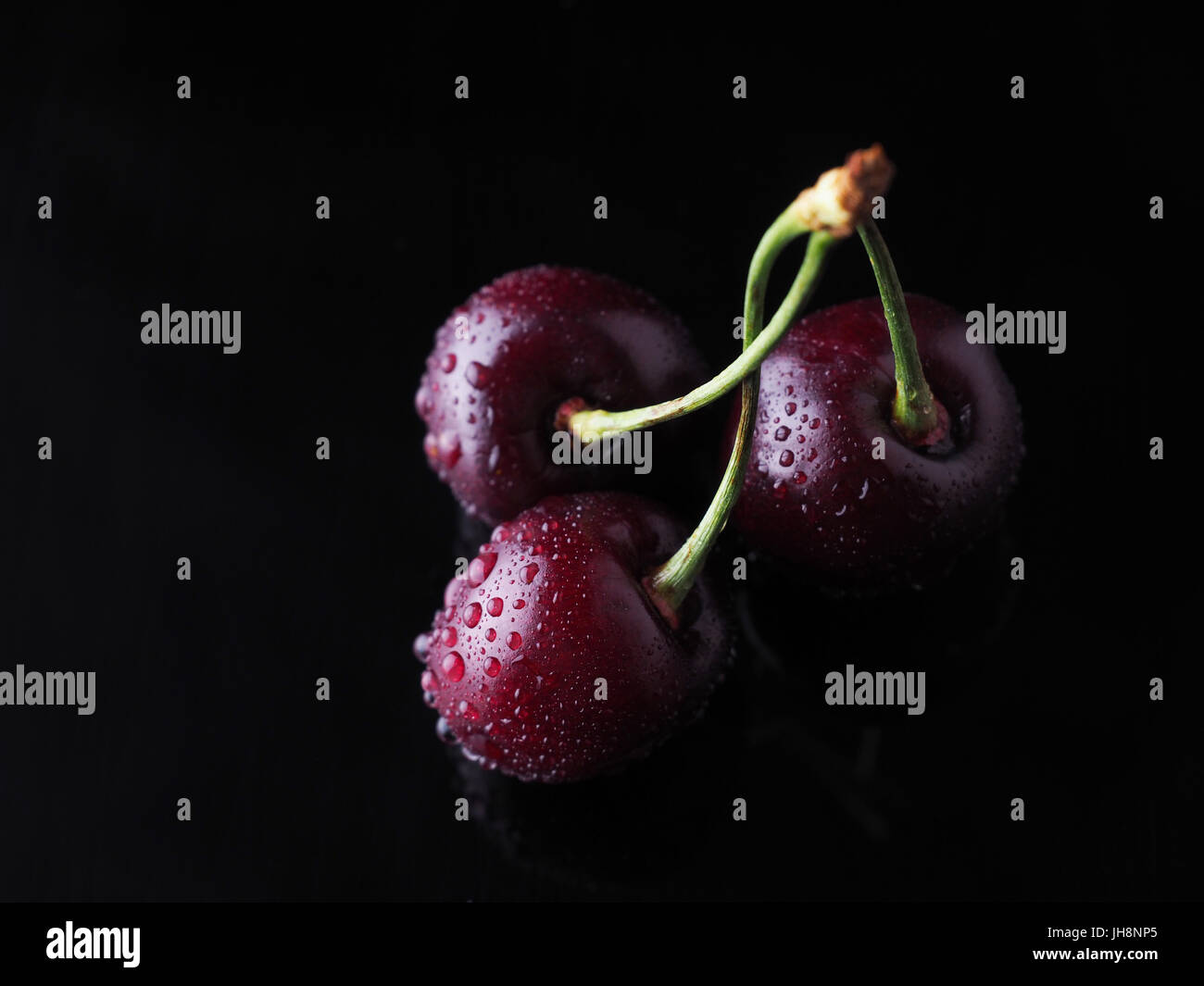 Cherry on a dark background Stock Photo - Alamy