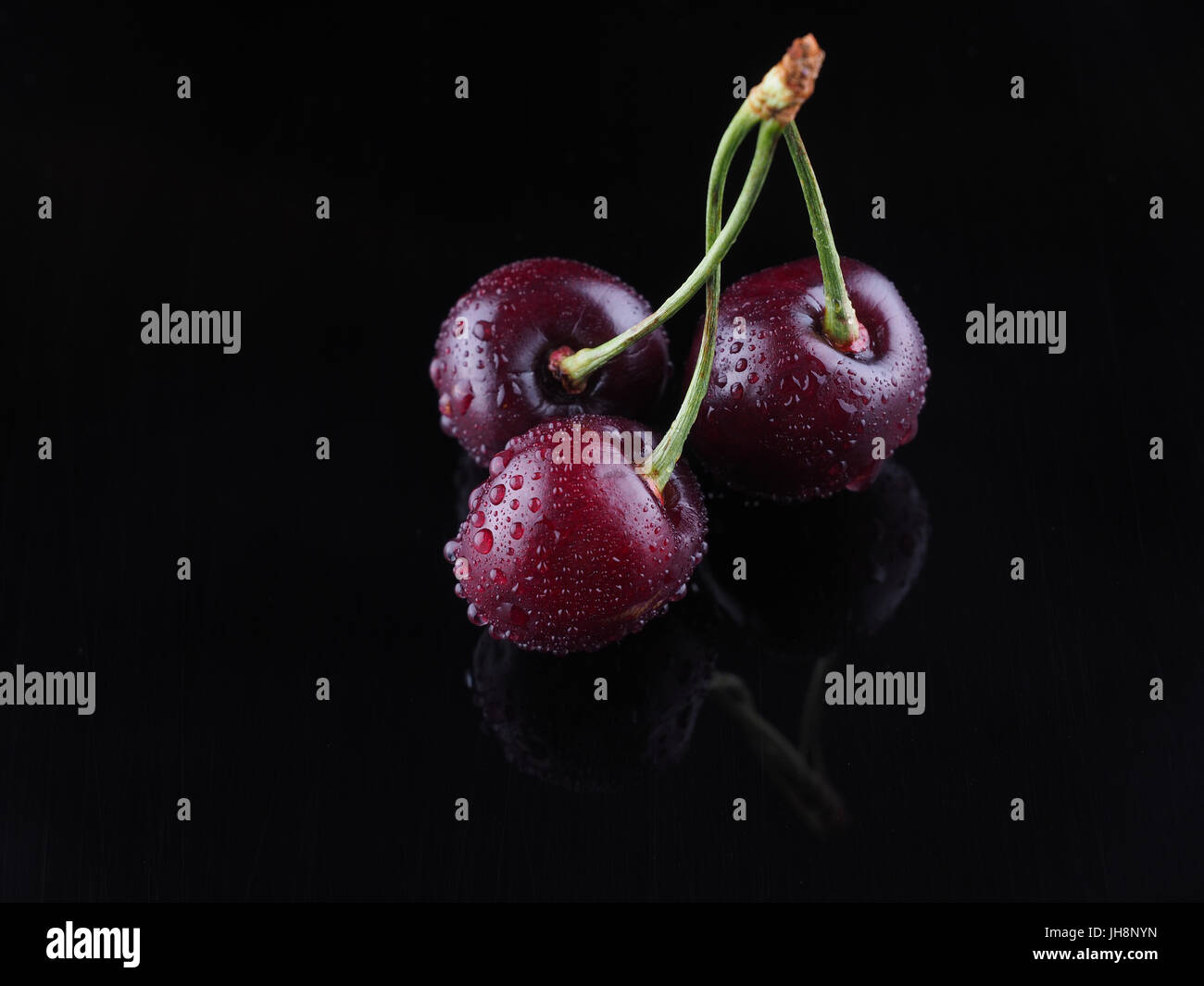 Cherry on a dark background Stock Photo - Alamy