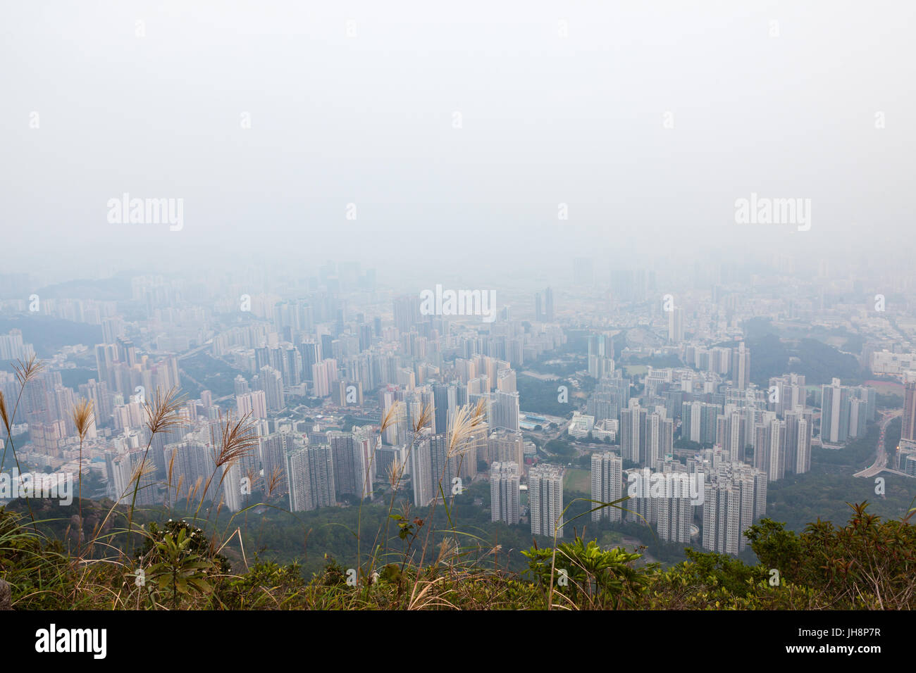 Hong kong tall buildings in haze Stock Photo - Alamy