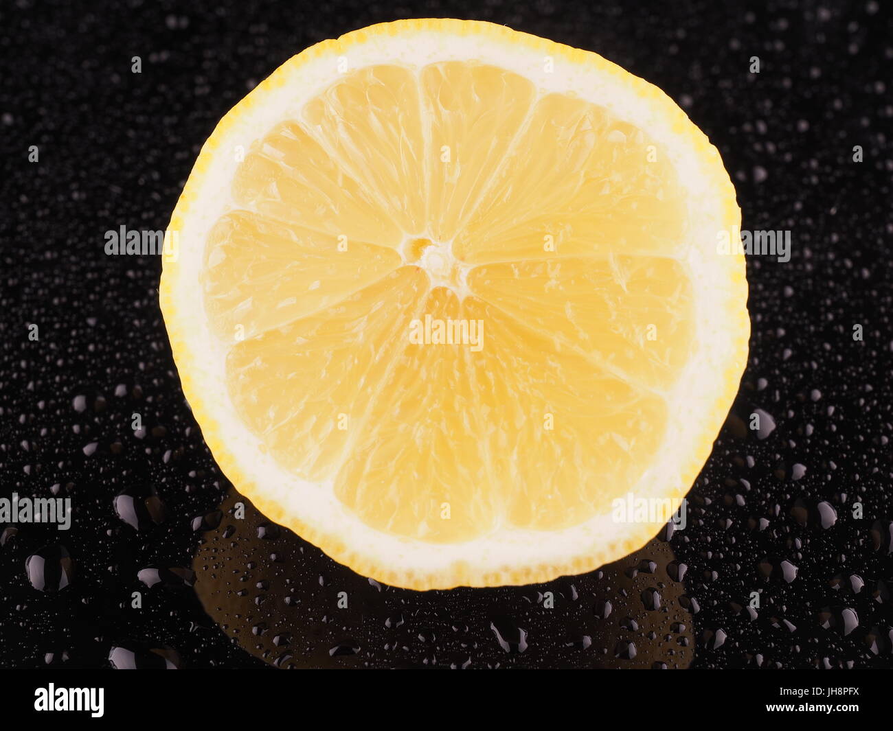 Lemon on a dark background with droplets Stock Photo - Alamy