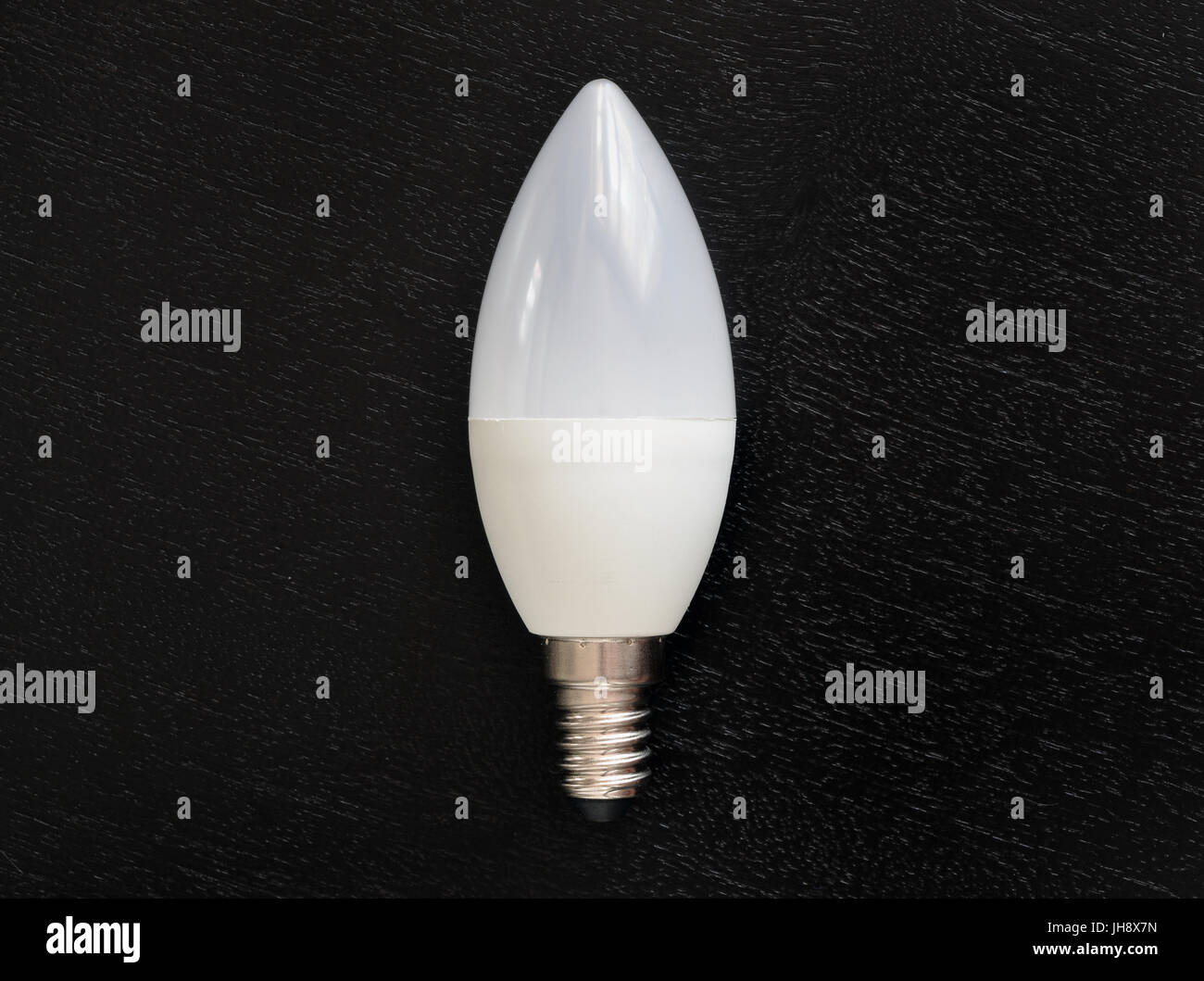 Glowing light bulb on black background hi-res stock photography and ...
