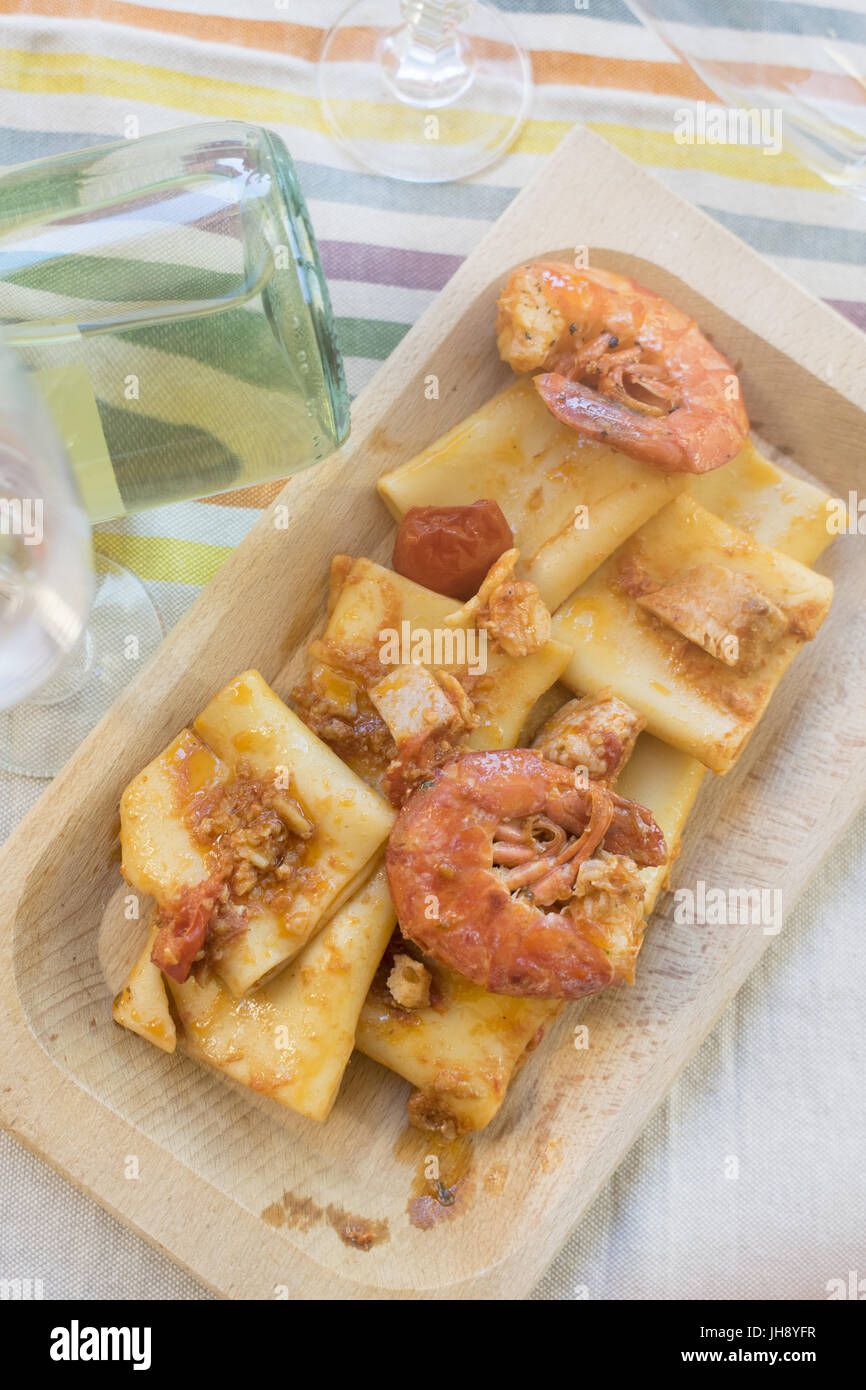 paccheri at the sauce of prawns in a wooden dish Stock Photo - Alamy