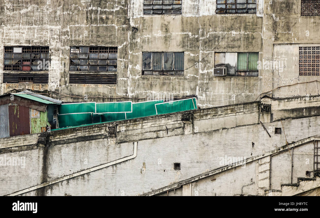 Aged brick wall with cracks and scuffs in slum region of Manila ...