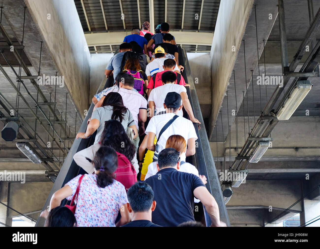 Manila, Philippines - Dec 21, 2015. People standing on escalator at ...