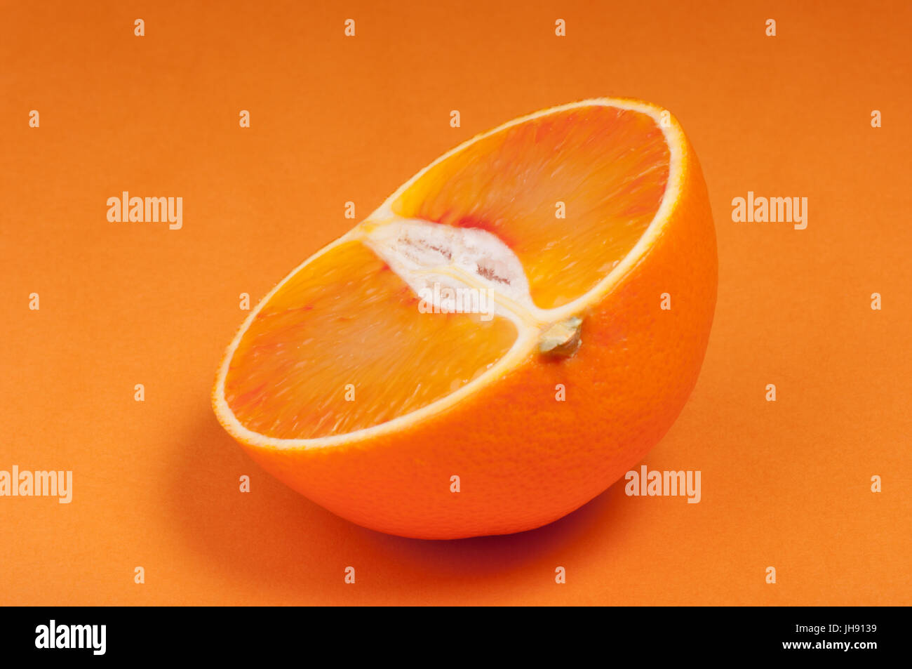 Half of blood red sicily orange. Studio shoot Stock Photo - Alamy