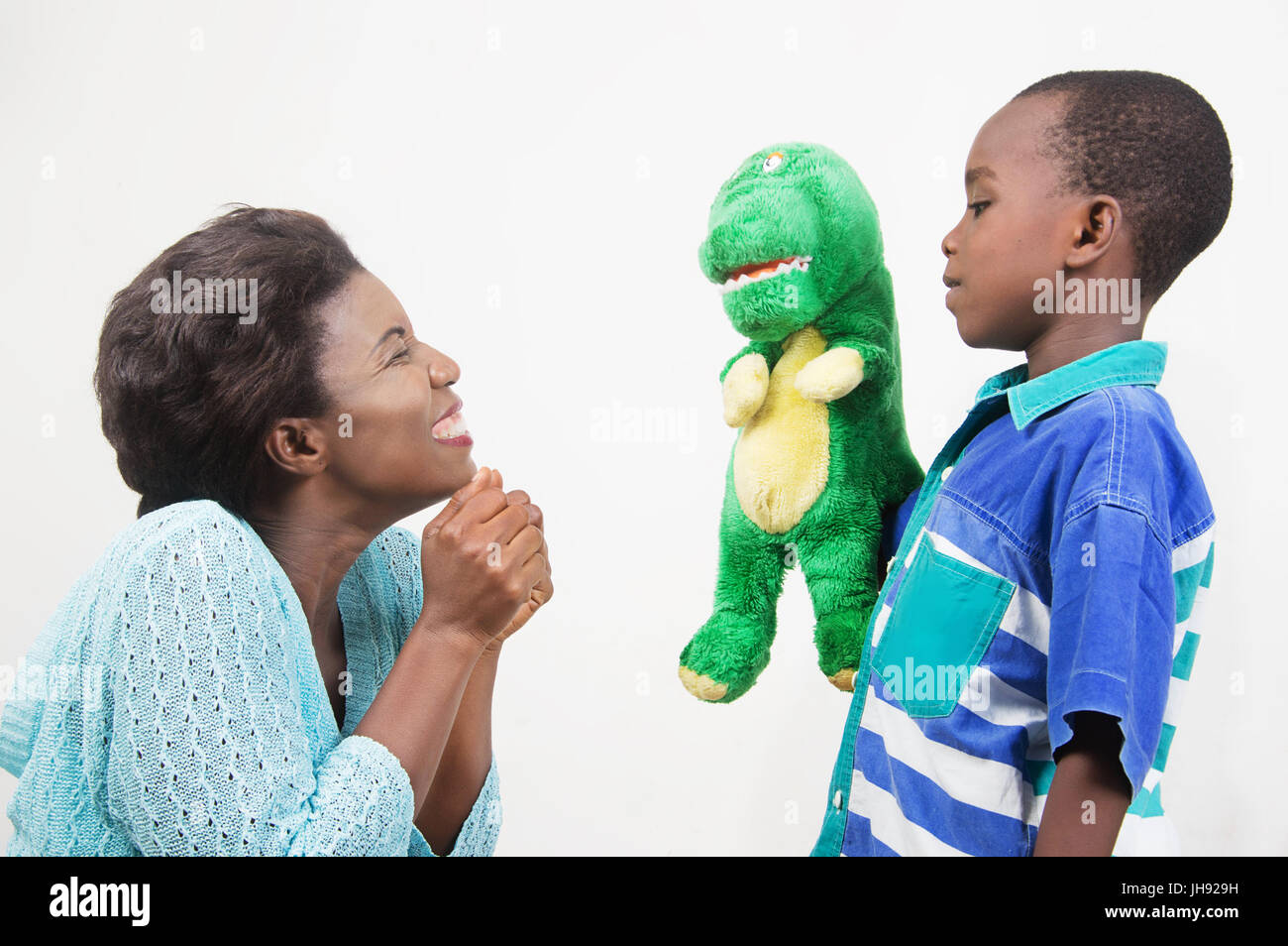 Child playing with his mother holding a toy in hand Stock Photo - Alamy