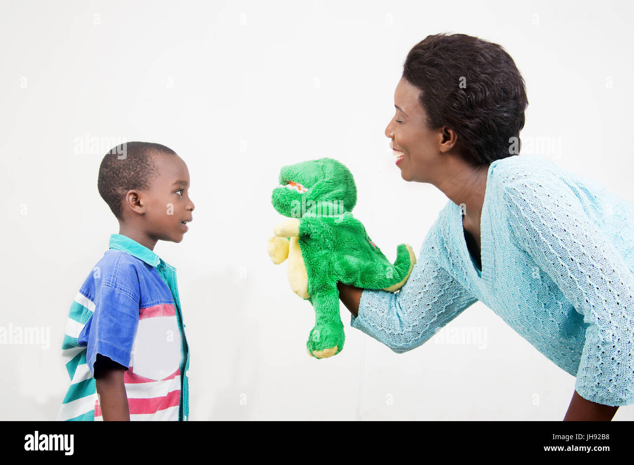 This young woman plays with her child taking a toy in hand Stock Photo ...